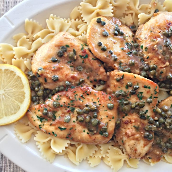 BEST Chicken Piccata Recipe - Buttery, lemon caper chicken over pasta