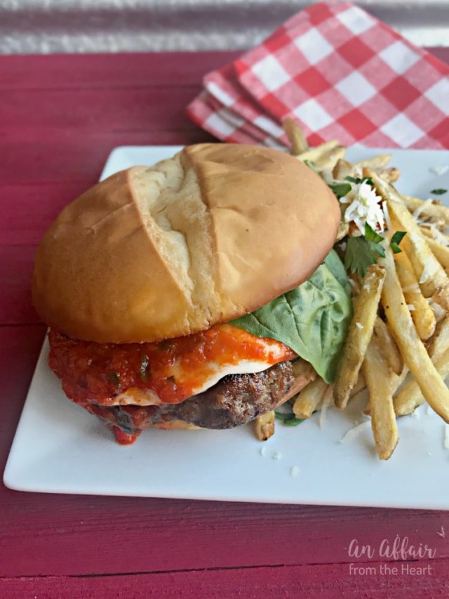 Italian Burger with fresh basil and mozzarella on a garlic bread bun.
