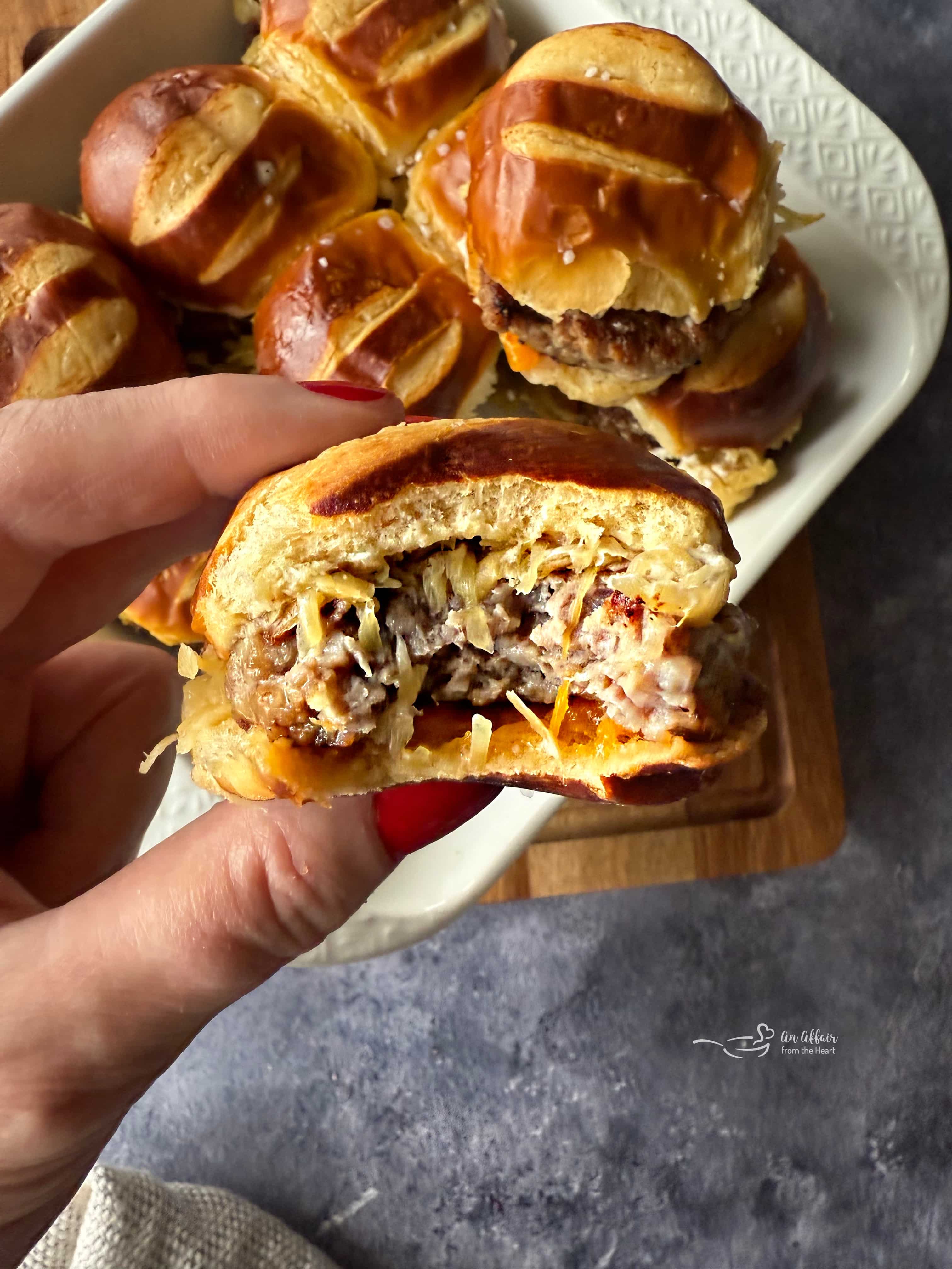 Bratwurst Sliders with Mustard Kraut on Pretzel Buns