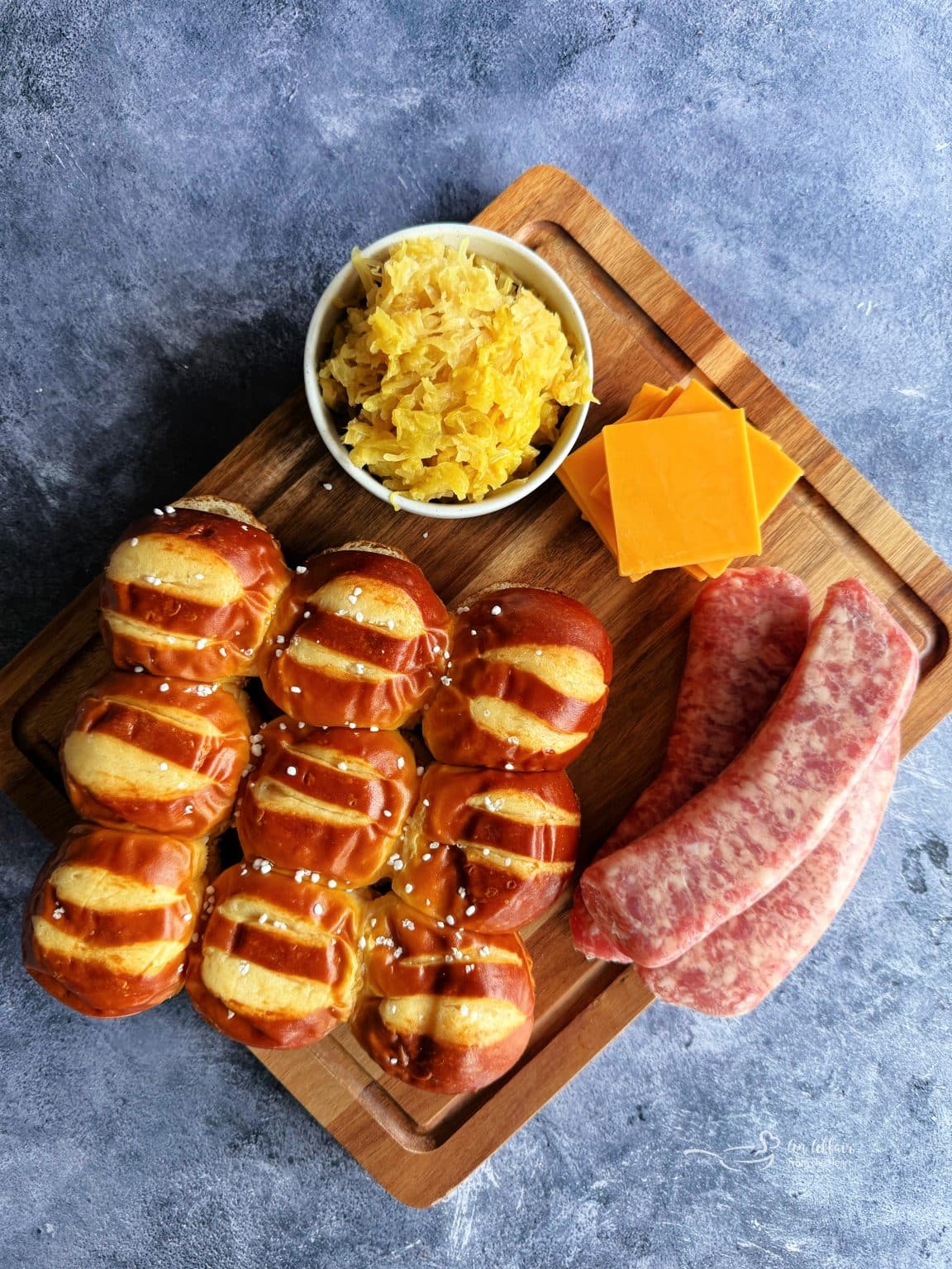 Bratwurst Sliders with Mustard Kraut on Pretzel Buns