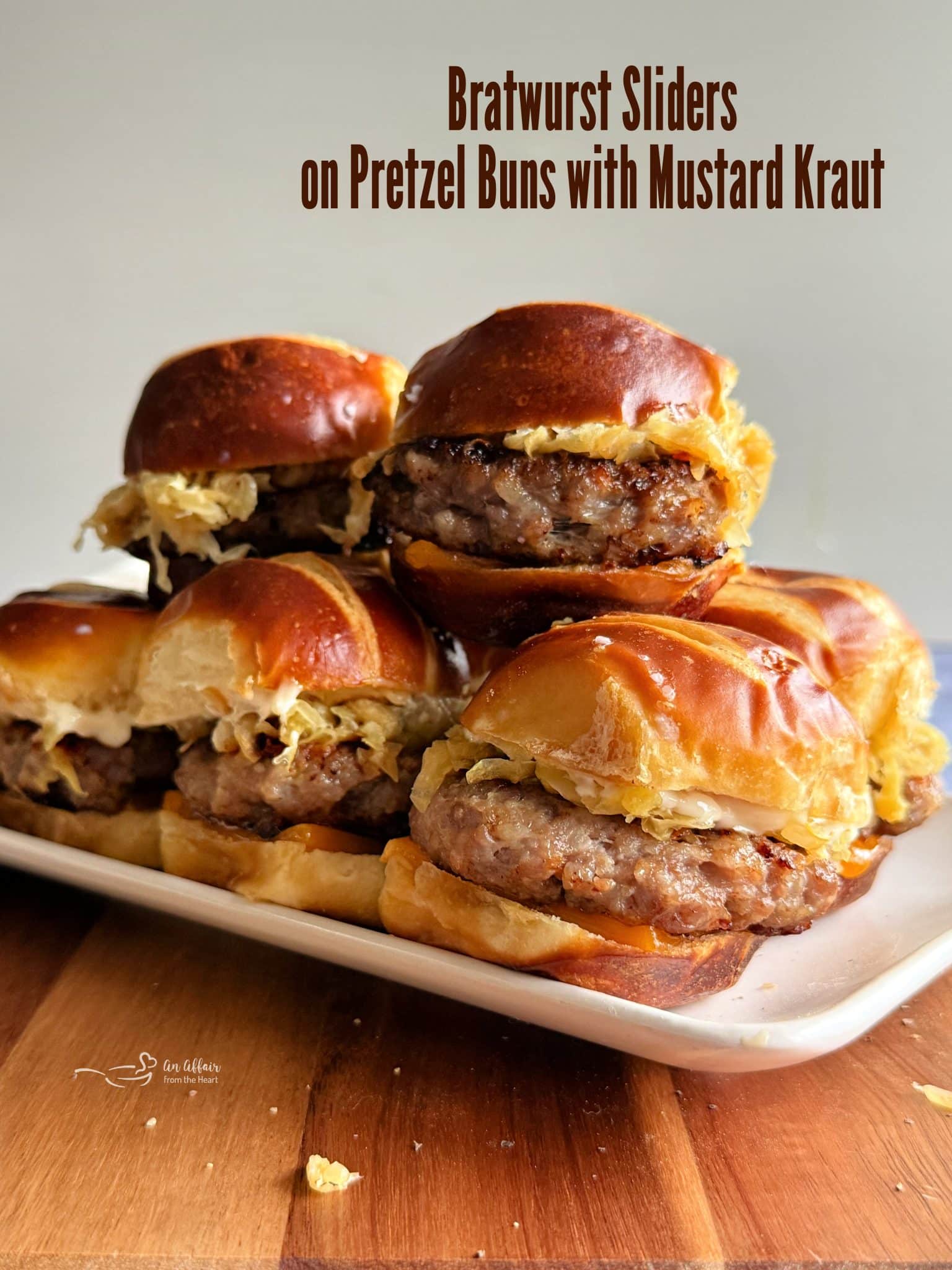 Bratwurst Sliders with Mustard Kraut on Pretzel Buns